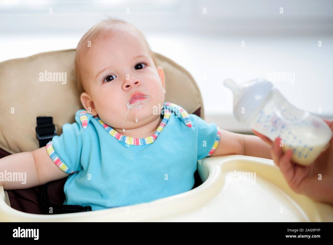 toddler sitting at the table and drinking milk Stock Photo - Alamy