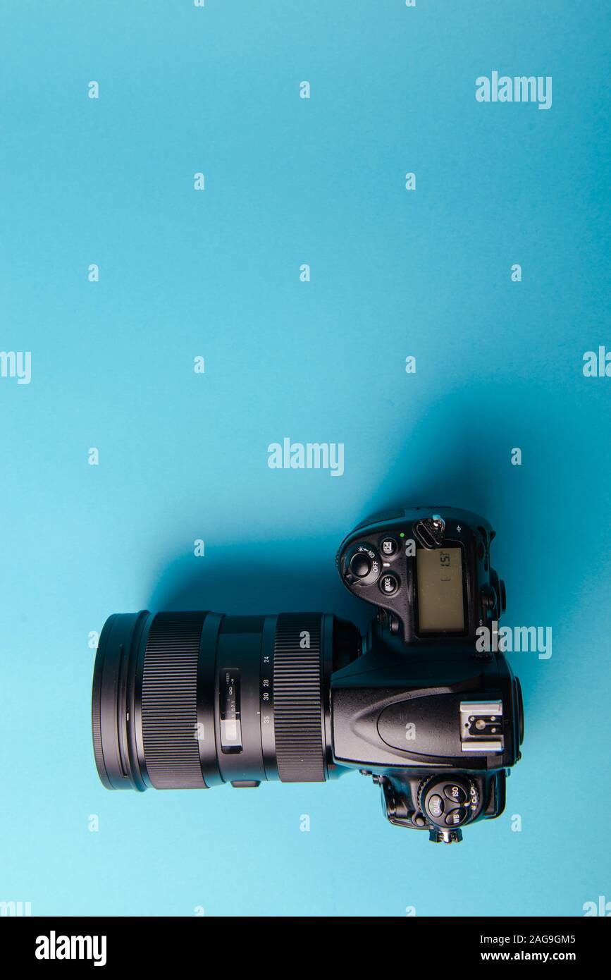Professional modern DSLR camera against blue background Stock Photo - Alamy