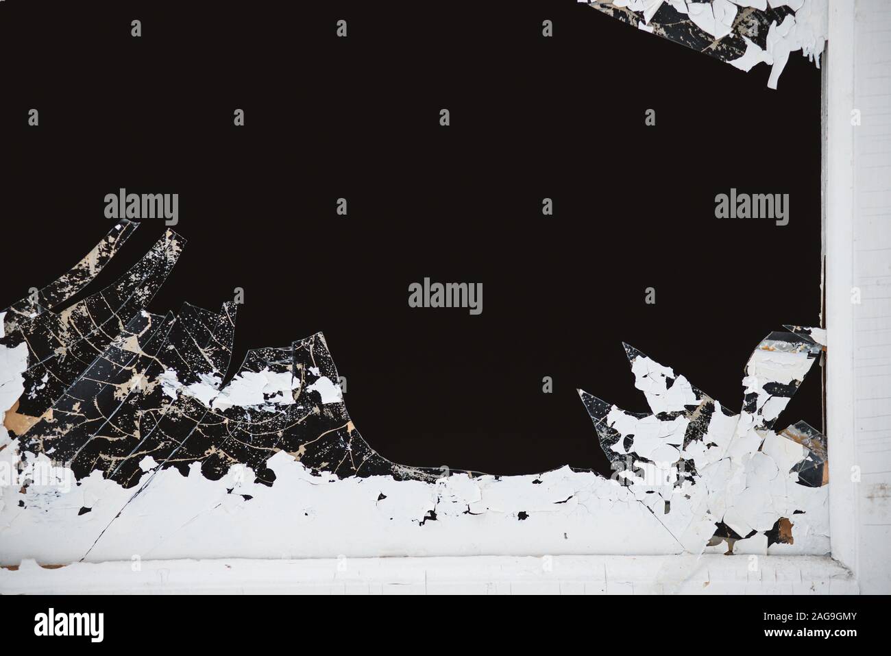 A broken window pane in the doorway, with sharp, dangerous edges of ...