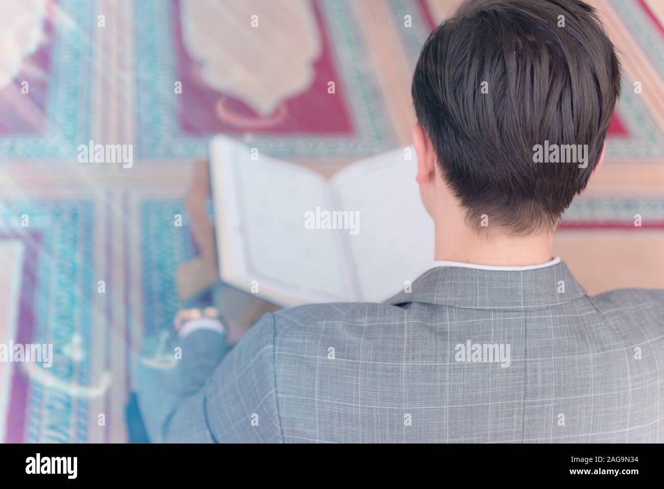 Religious young hafiz muslim man praying inside the mosque and reading ...
