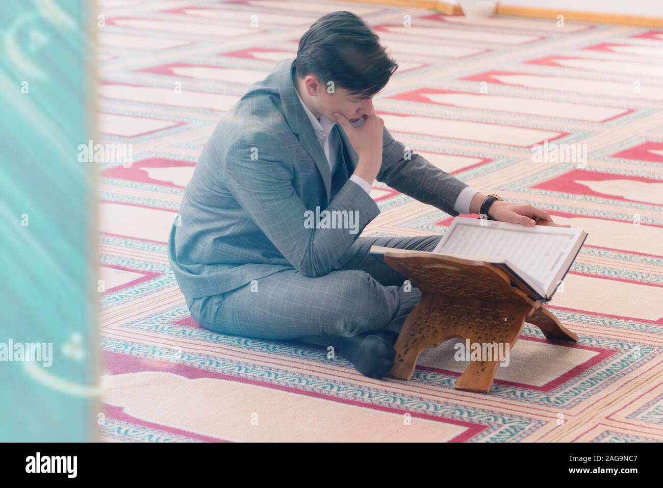 Religious young hafiz muslim man praying inside the mosque and reading ...