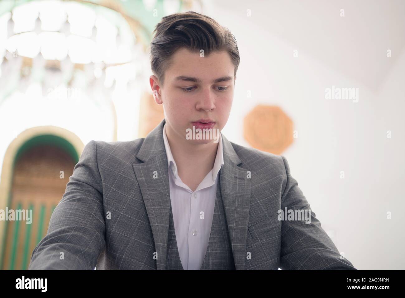 Religious young hafiz muslim man praying inside the mosque and reading ...