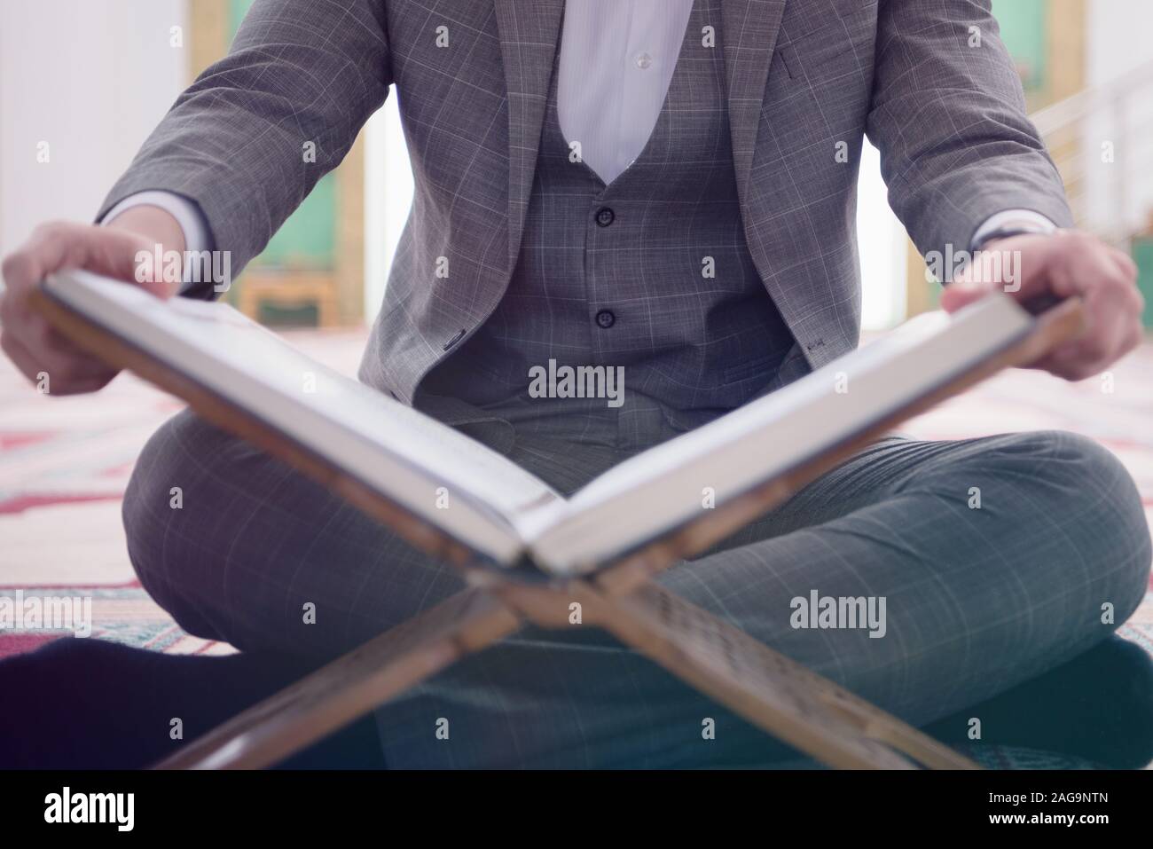 Religious young hafiz muslim man praying inside the mosque and reading ...