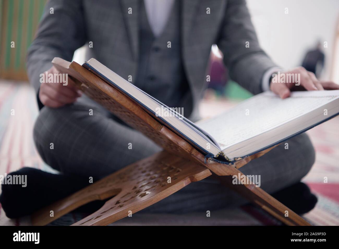 Religious young hafiz muslim man praying inside the mosque and reading ...