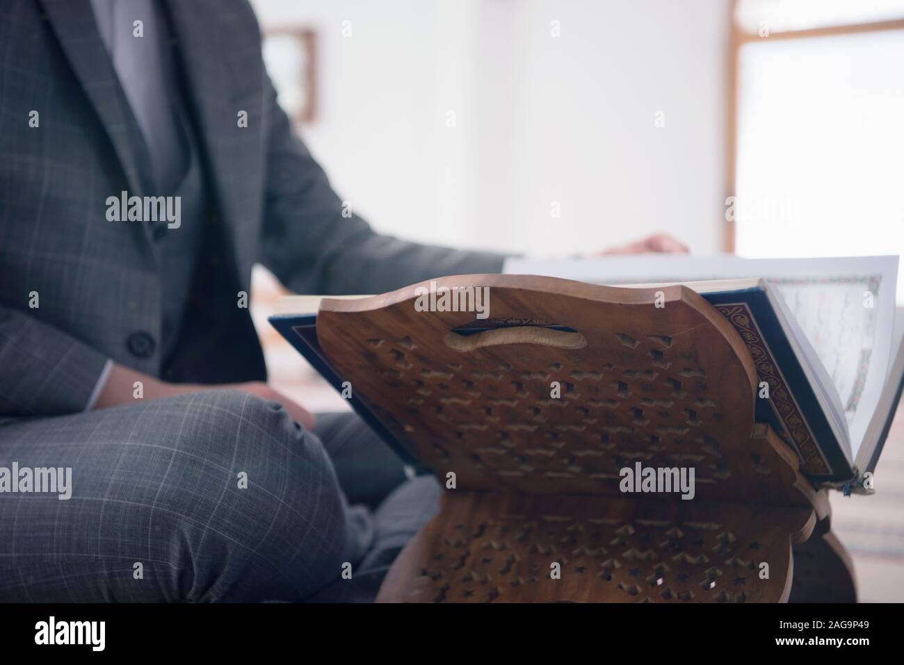 Religious young hafiz muslim man praying inside the mosque and reading ...