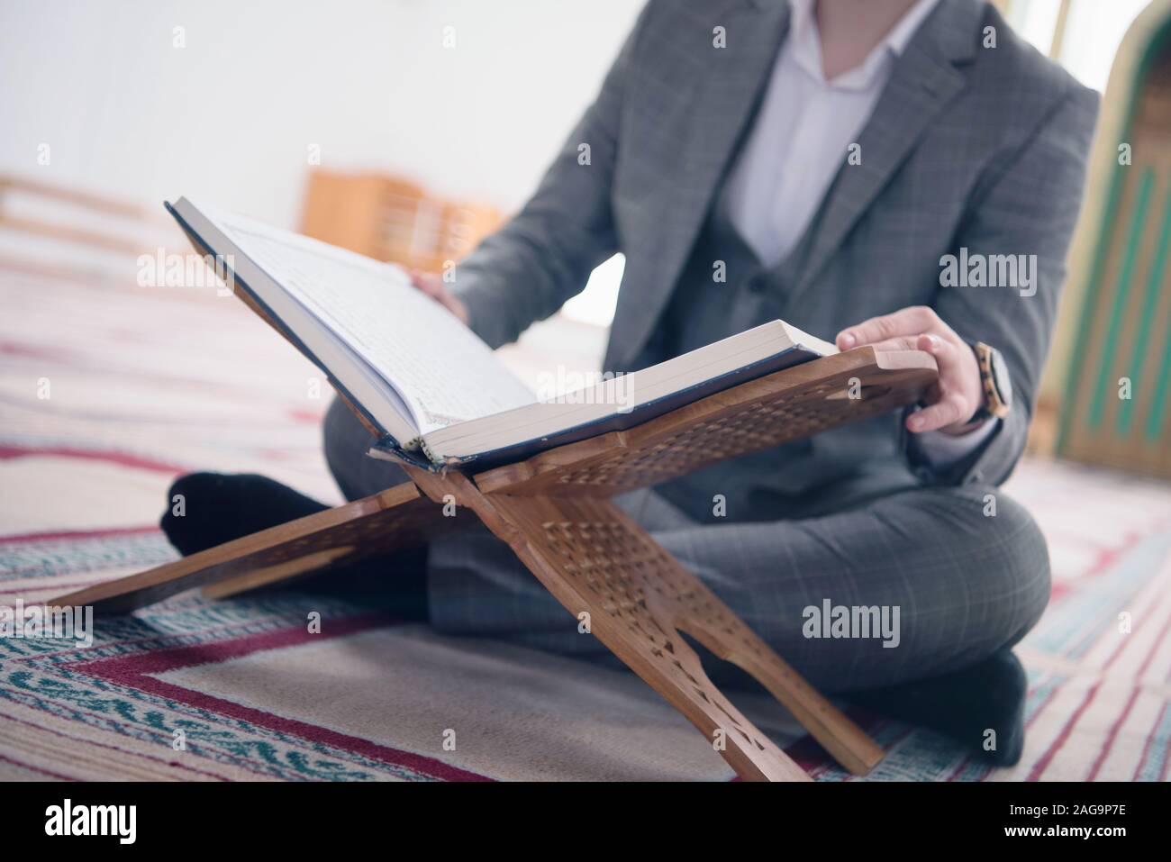 Religious young hafiz muslim man praying inside the mosque and reading ...