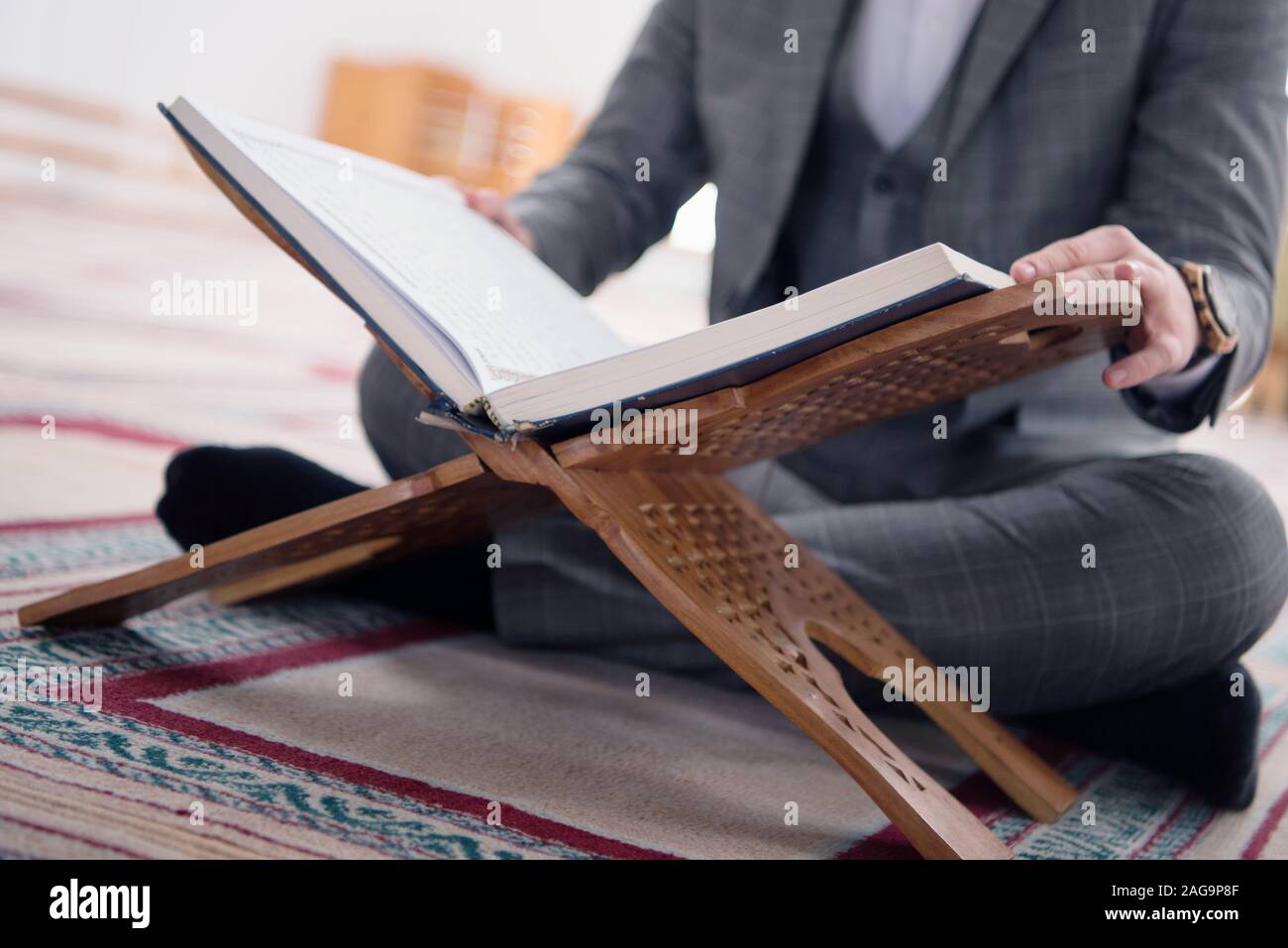 Religious young hafiz muslim man praying inside the mosque and reading ...