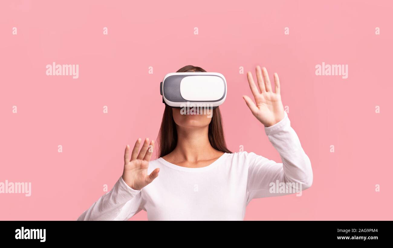 Millennial Girl Using Virtual Reality Headset Over Pink Background ...