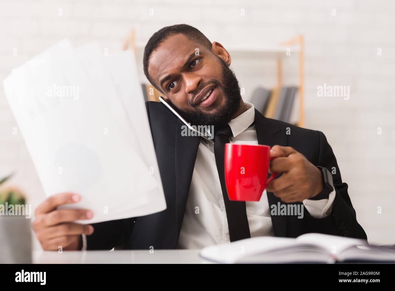 Male boss checking report on hi-res stock photography and images - Alamy