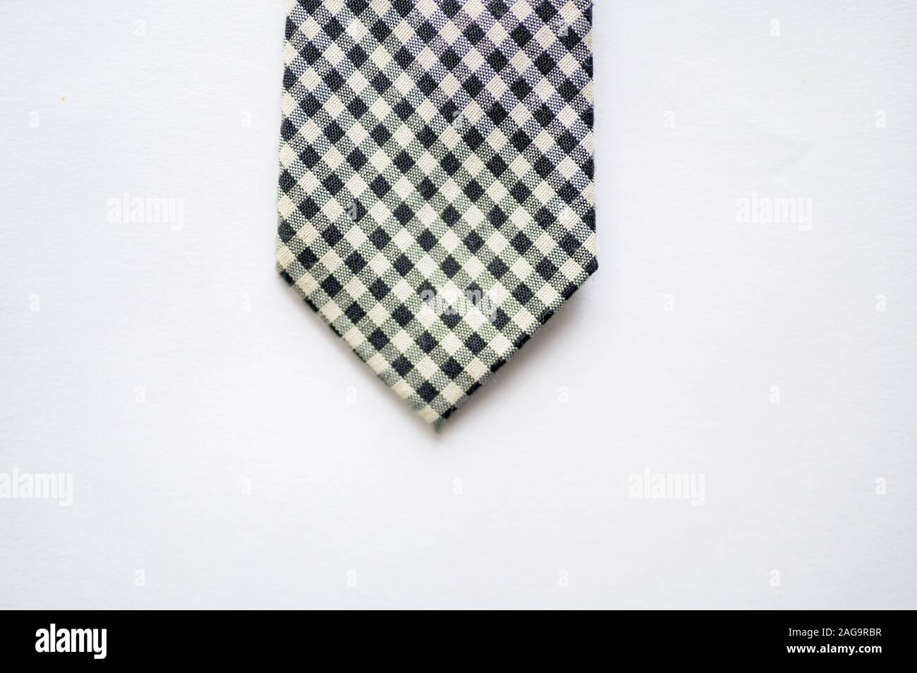 Overhead shot of a black and white tie on a white surface Stock Photo ...