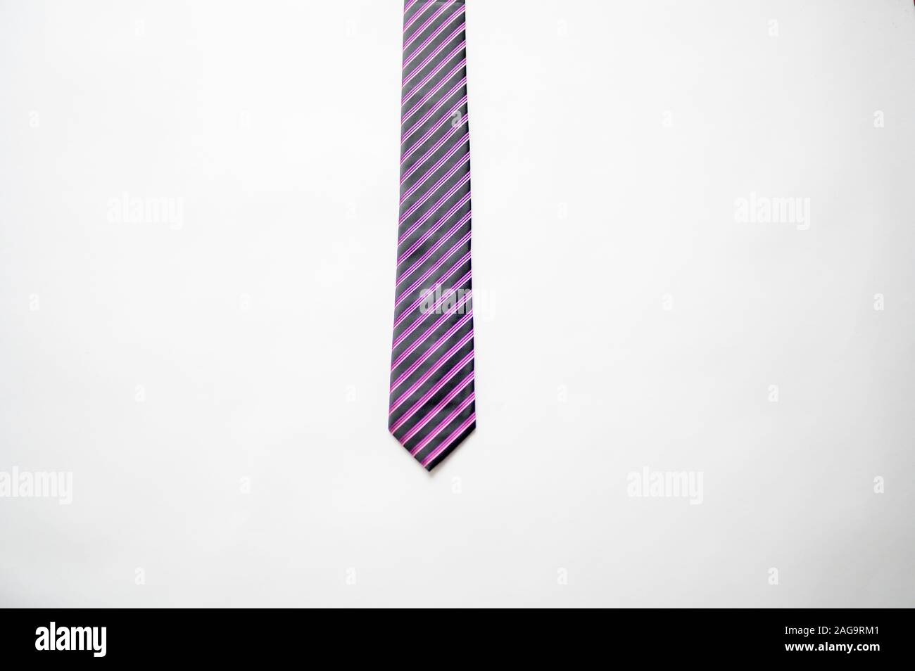 Overhead shot of a purple striped tie on a white surface Stock Photo ...