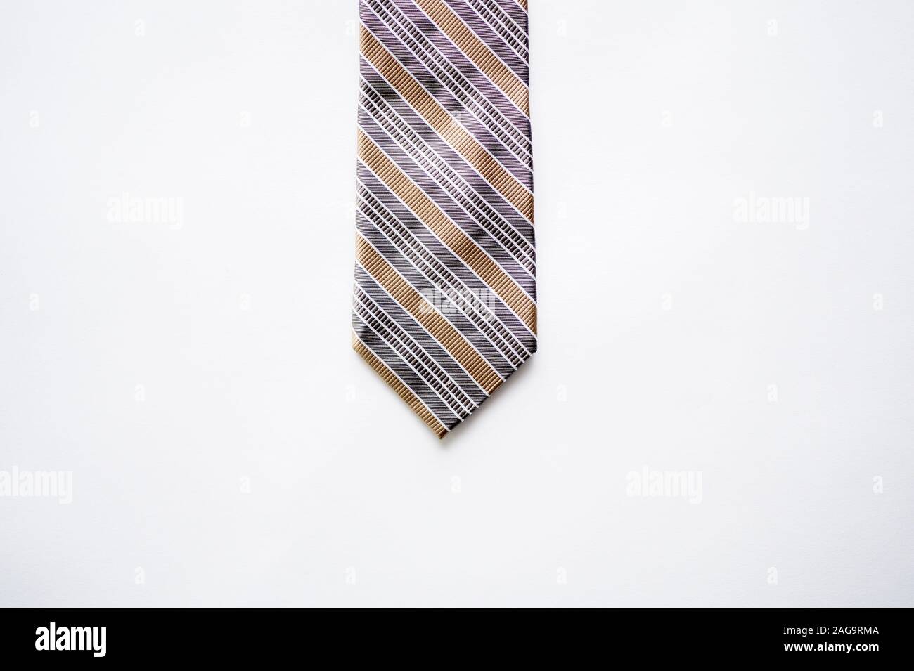 Overhead shot of a striped tie on a white surface Stock Photo - Alamy