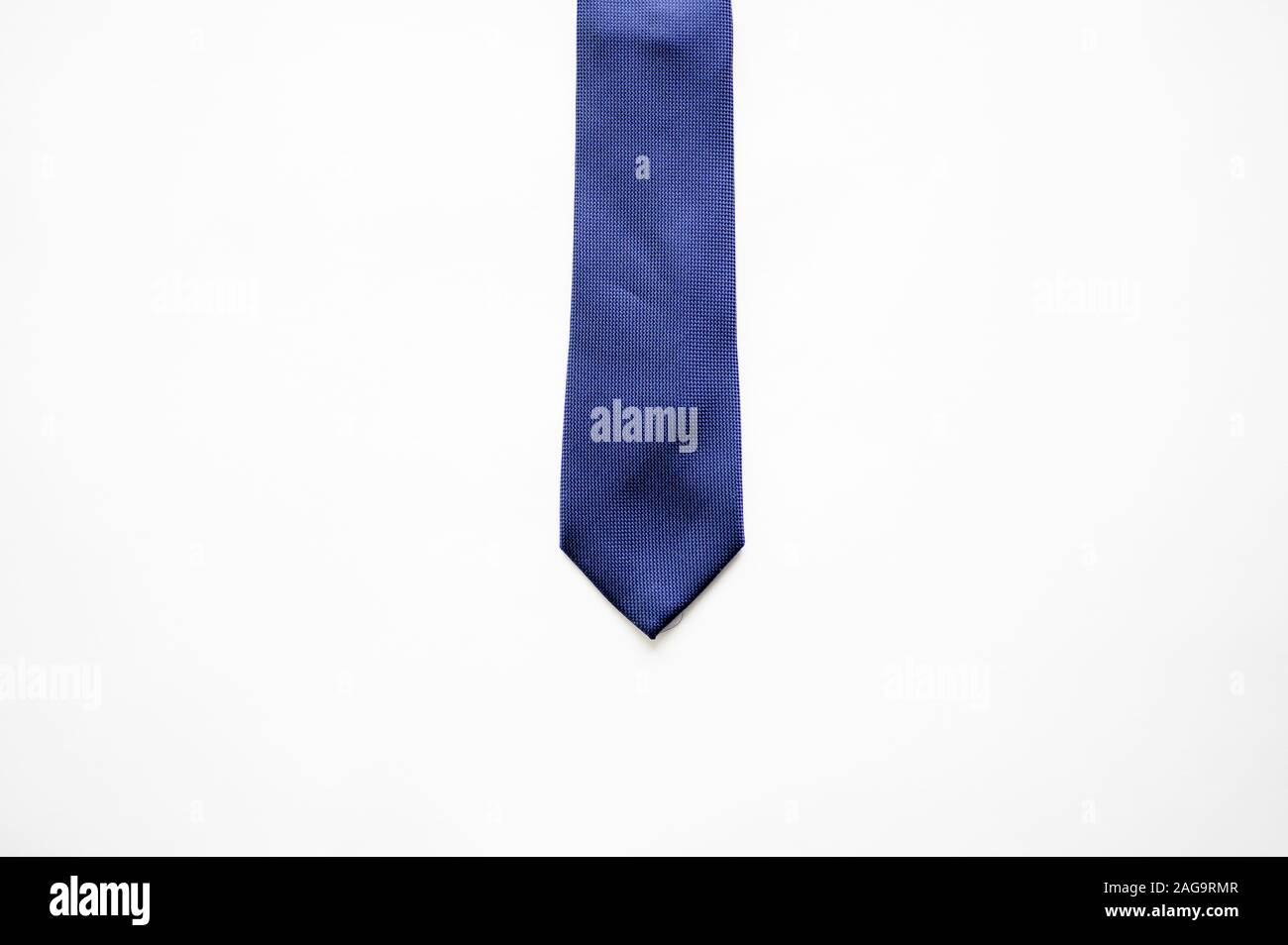 Overhead shot of a blue tie on a white surface Stock Photo - Alamy