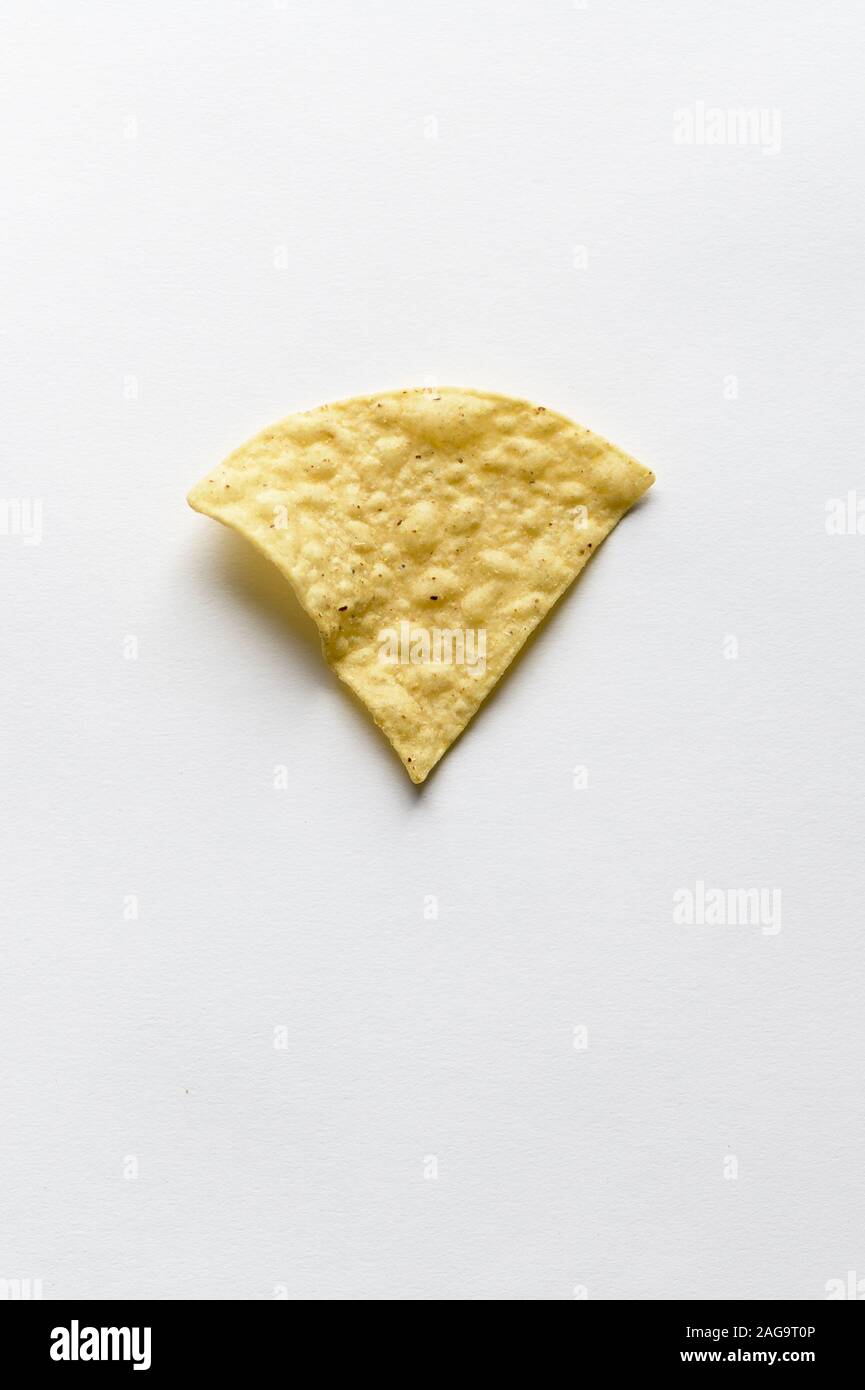 Vertical overhead shot of a single nacho on a white surface Stock Photo ...
