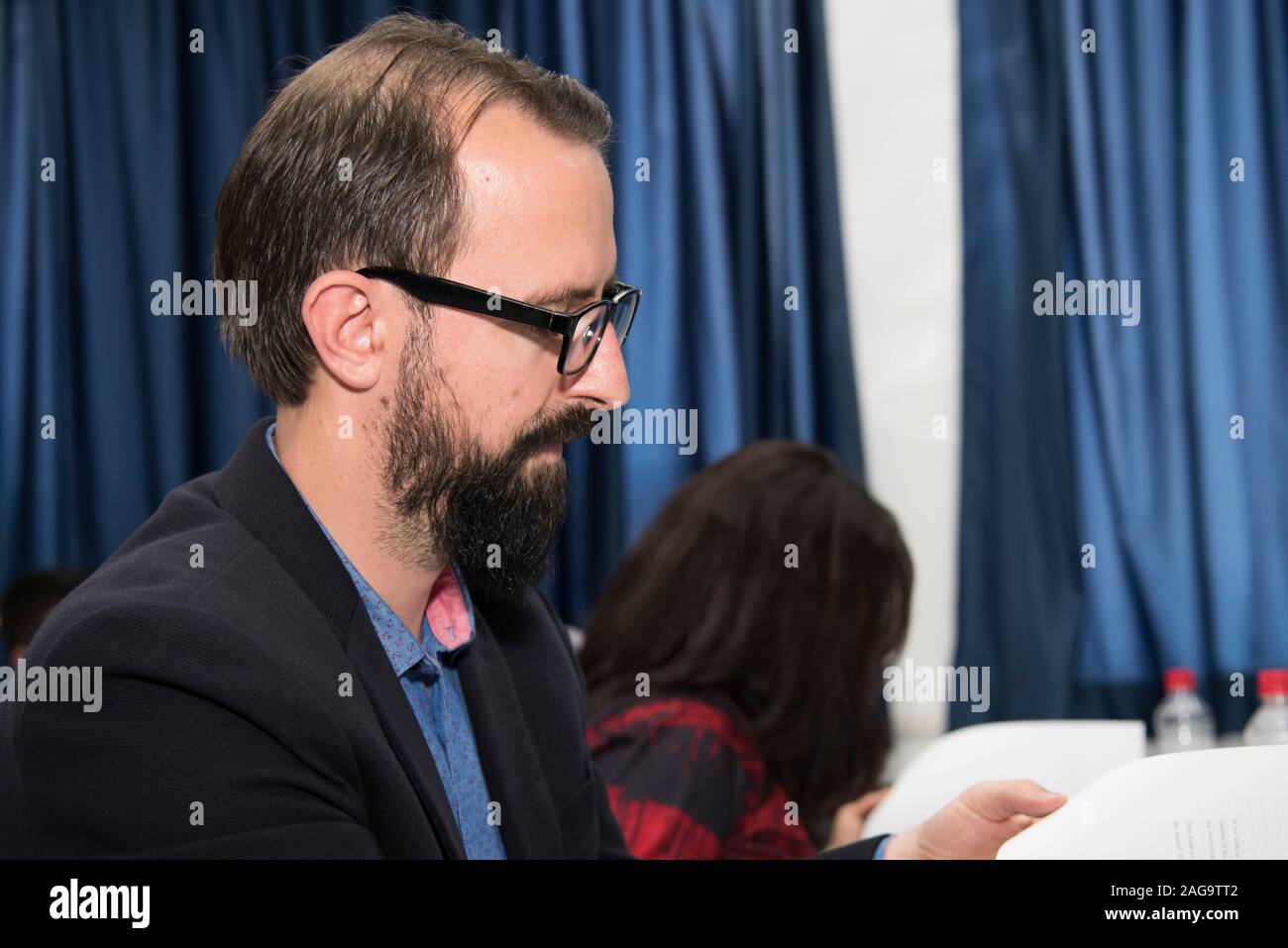 Male academic professor holding a test and examines the student. Exams ...
