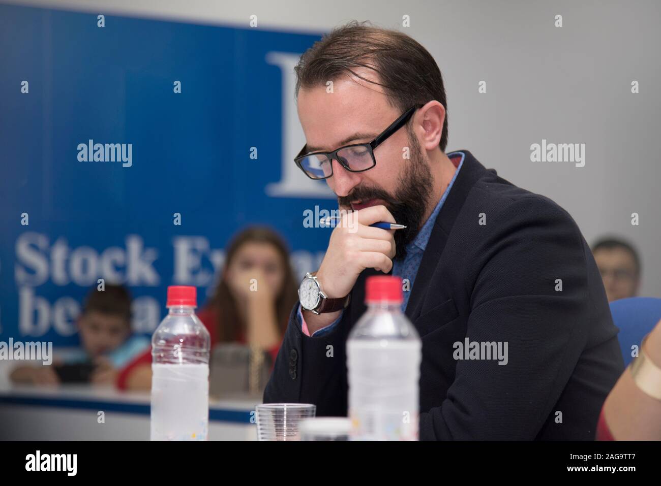 Male academic professor holding a test and examines the student. Exams ...