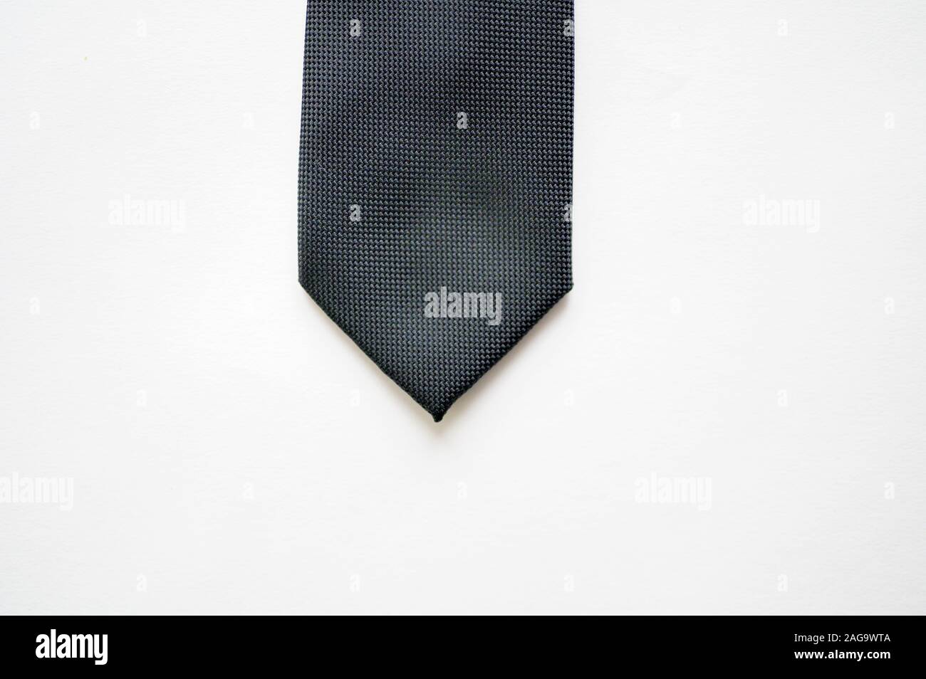 Overhead shot of a black tie on a white surface Stock Photo - Alamy