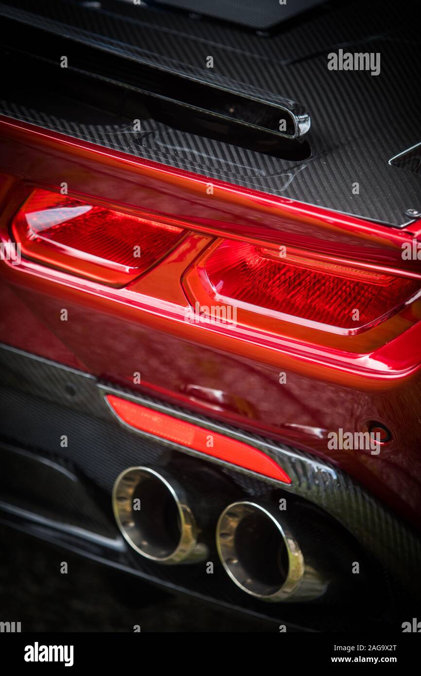 Close up vertical image of the LED tail lights and exhaust pipes of a ...