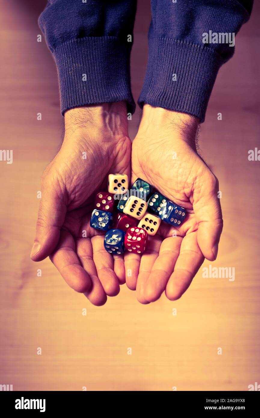 open male hands holding various colorful dice Stock Photo - Alamy