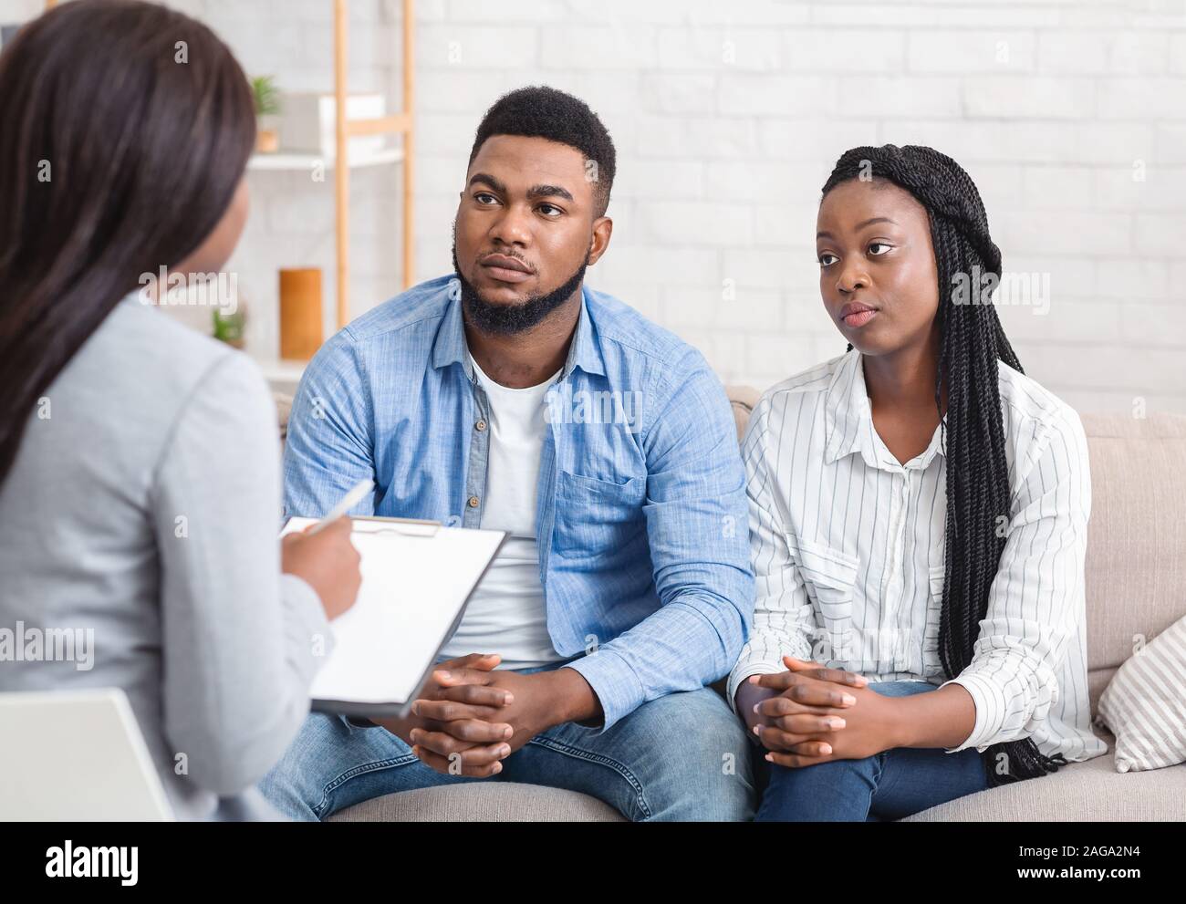 Sad afro couple listening hi-res stock photography and images - Alamy