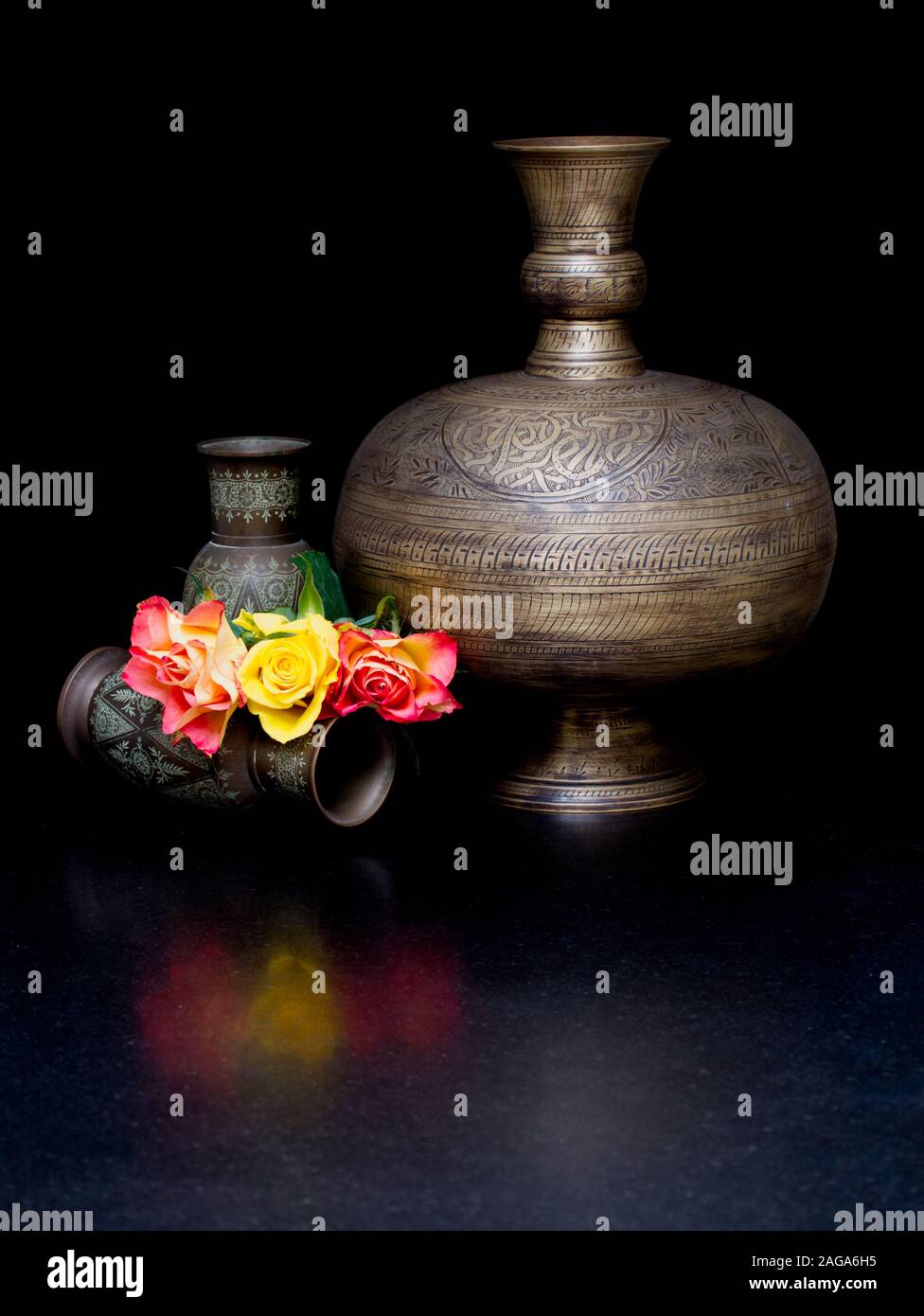 Classical still Life setting with Roses, Brass and Copper Urn and Vases ...