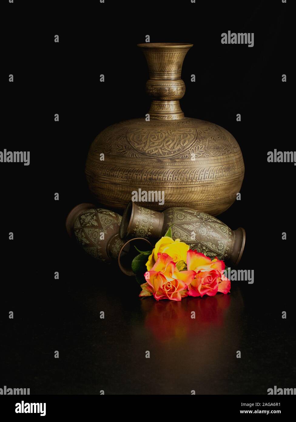 Classical Still Life setting with Roses, Brass and Copper Urn and Vases ...