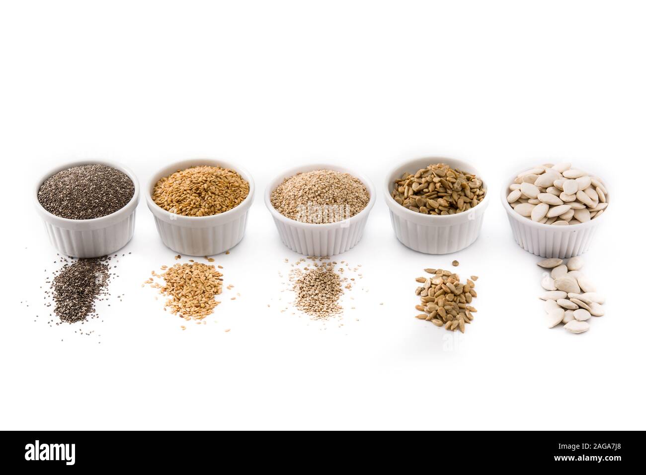Assortment of different seeds in bowl isolated on white background ...