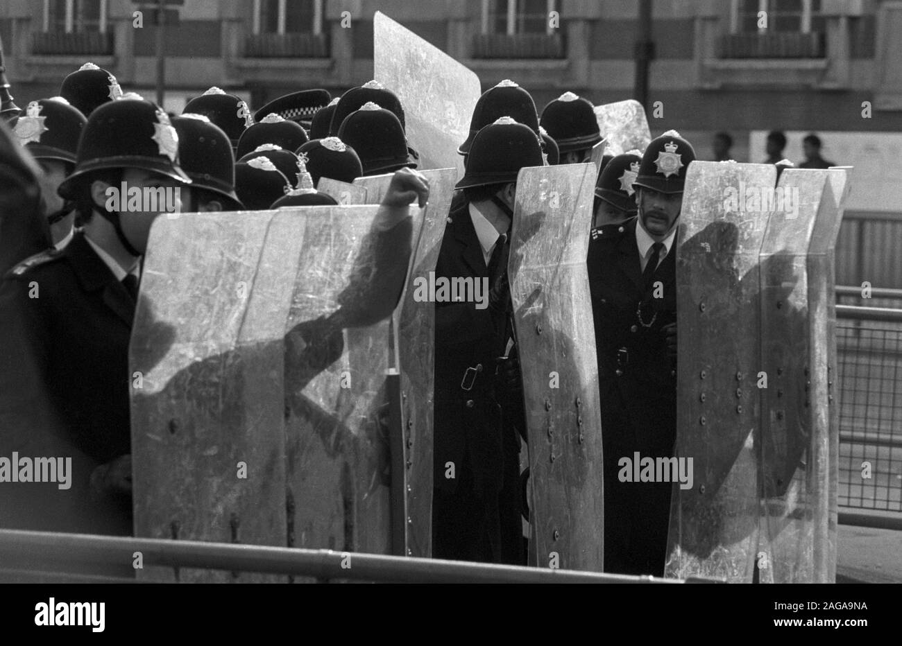 Police protect themselves with riot shields for the second night in ...