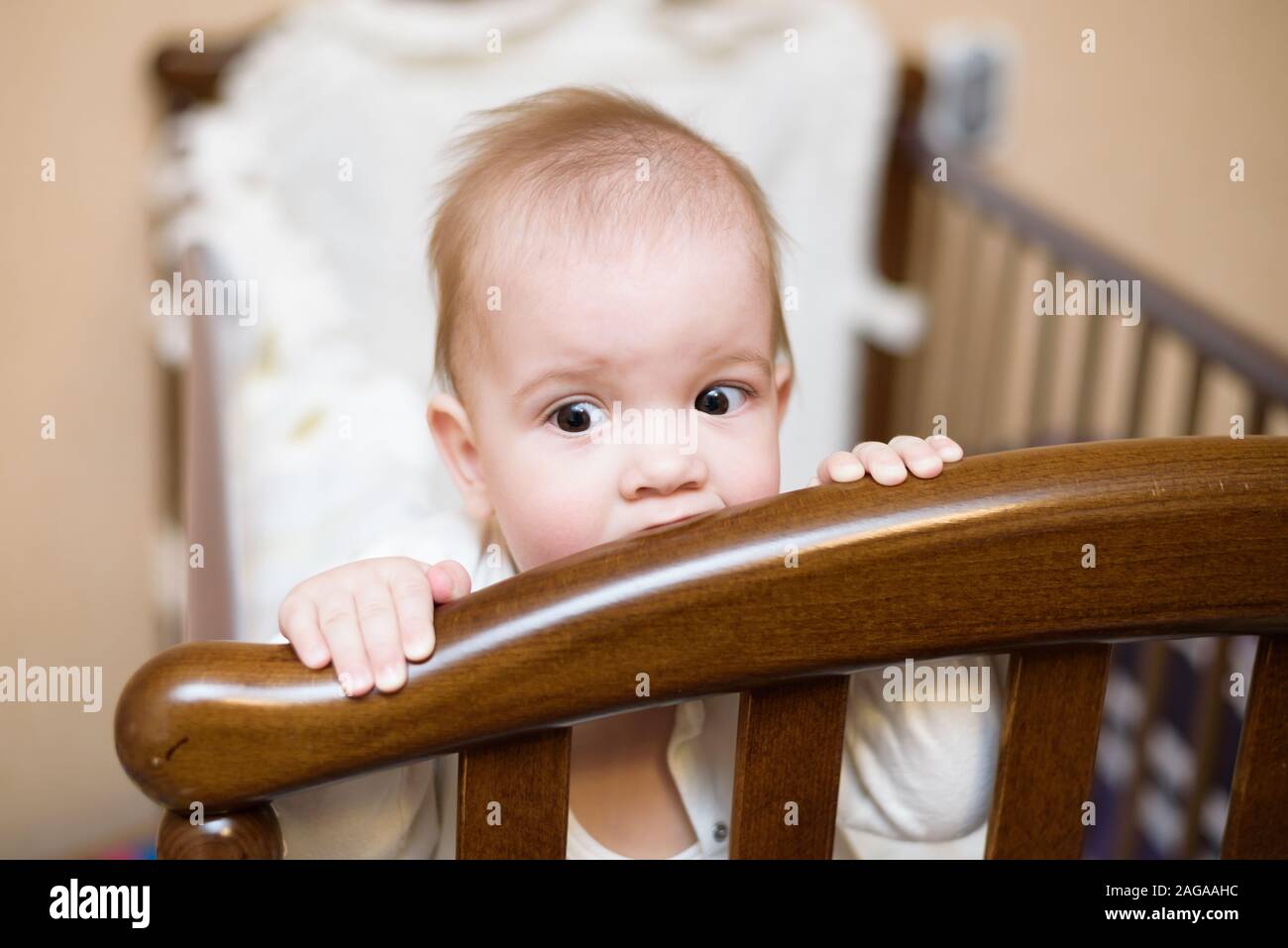 little boy chewing on her bed at home Stock Photo - Alamy