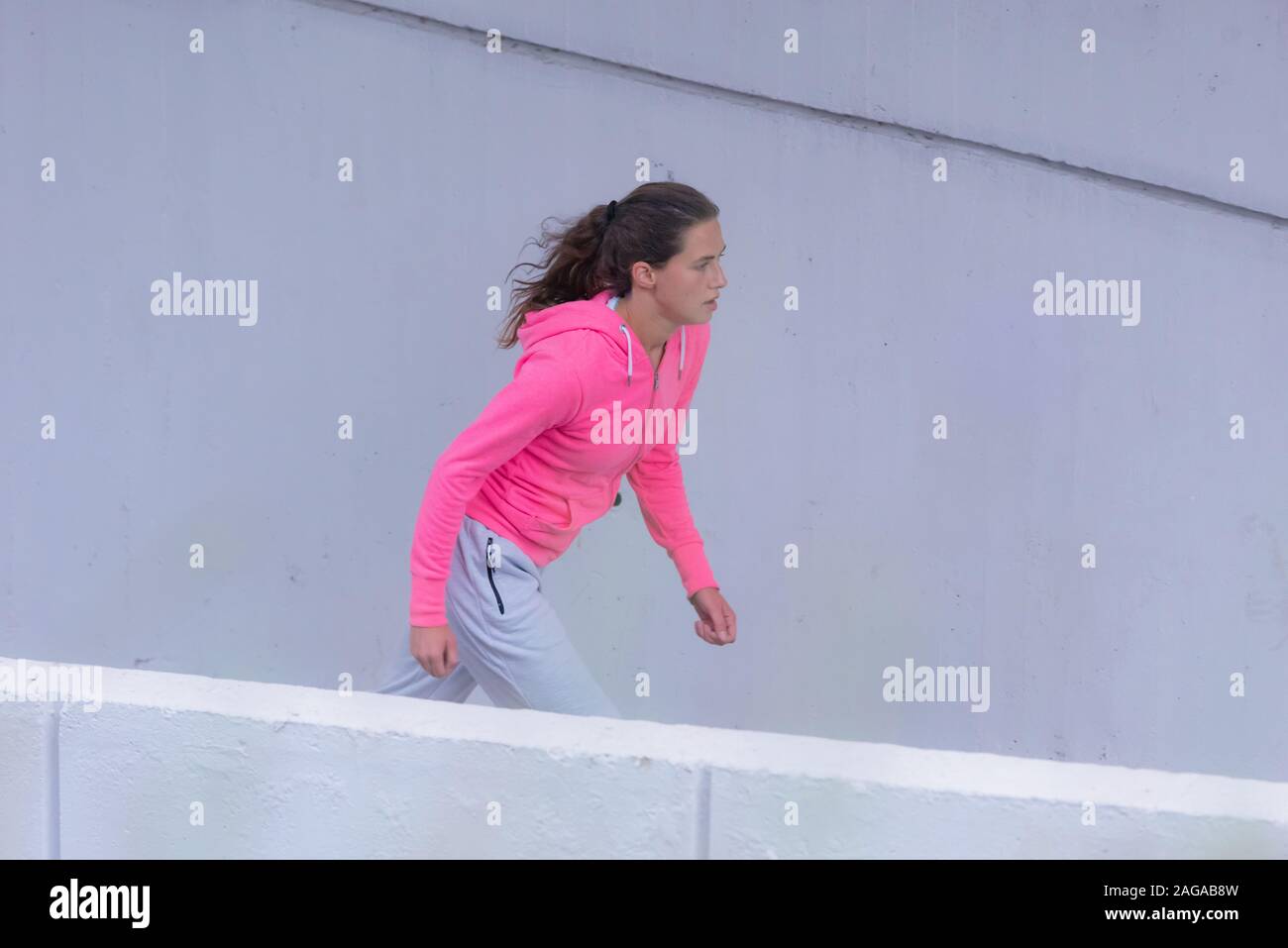 Running woman. Female fitness model training outside in the city Stock ...