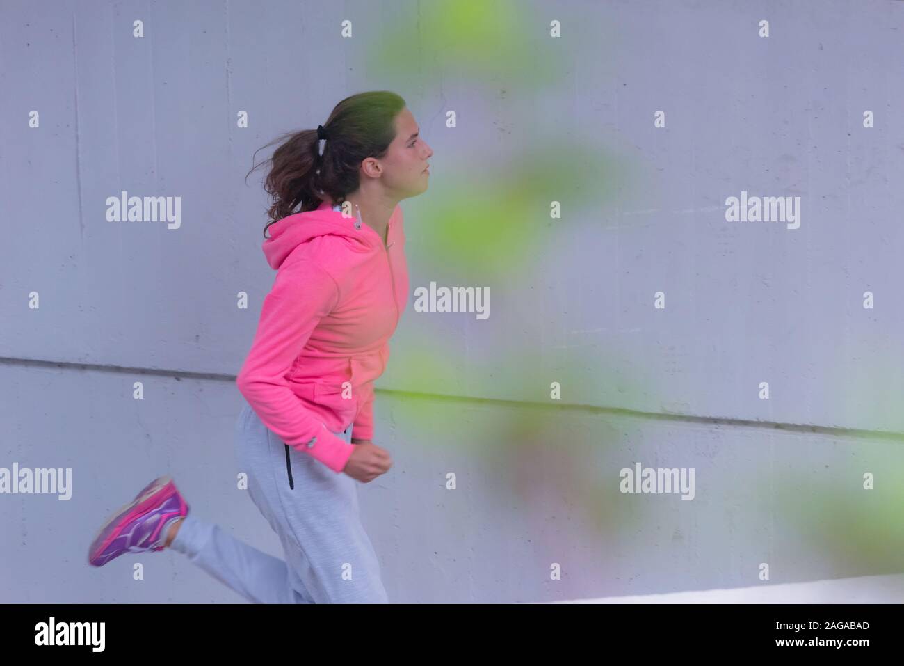 Running woman. Female fitness model training outside in the city Stock ...