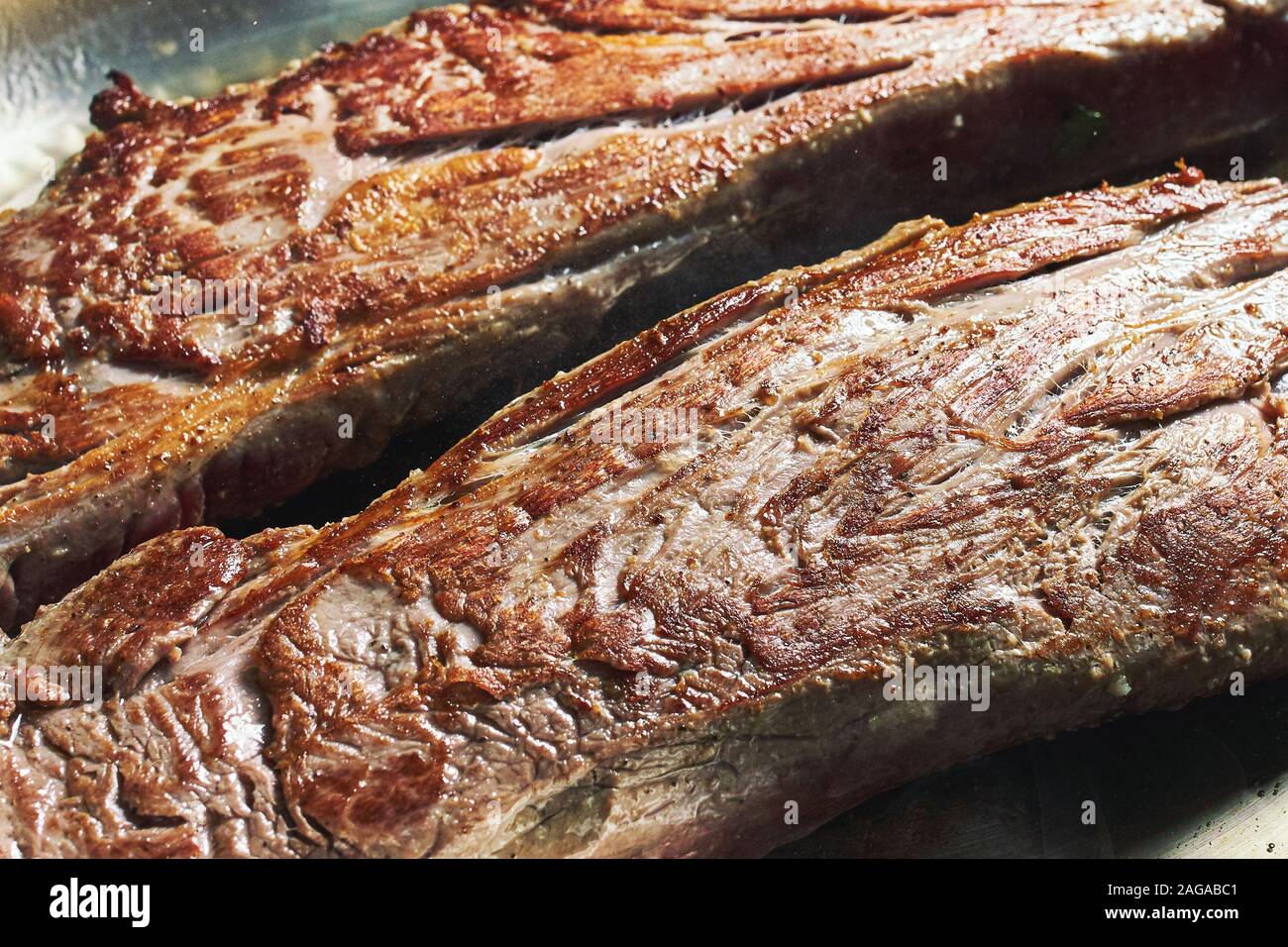 Cooking beef in a restaurant. steak and chef. closeup piece of roast ...