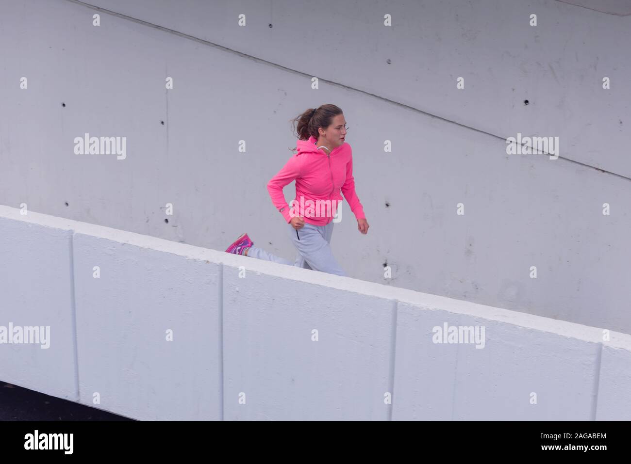 Running woman. Female fitness model training outside in the city Stock ...