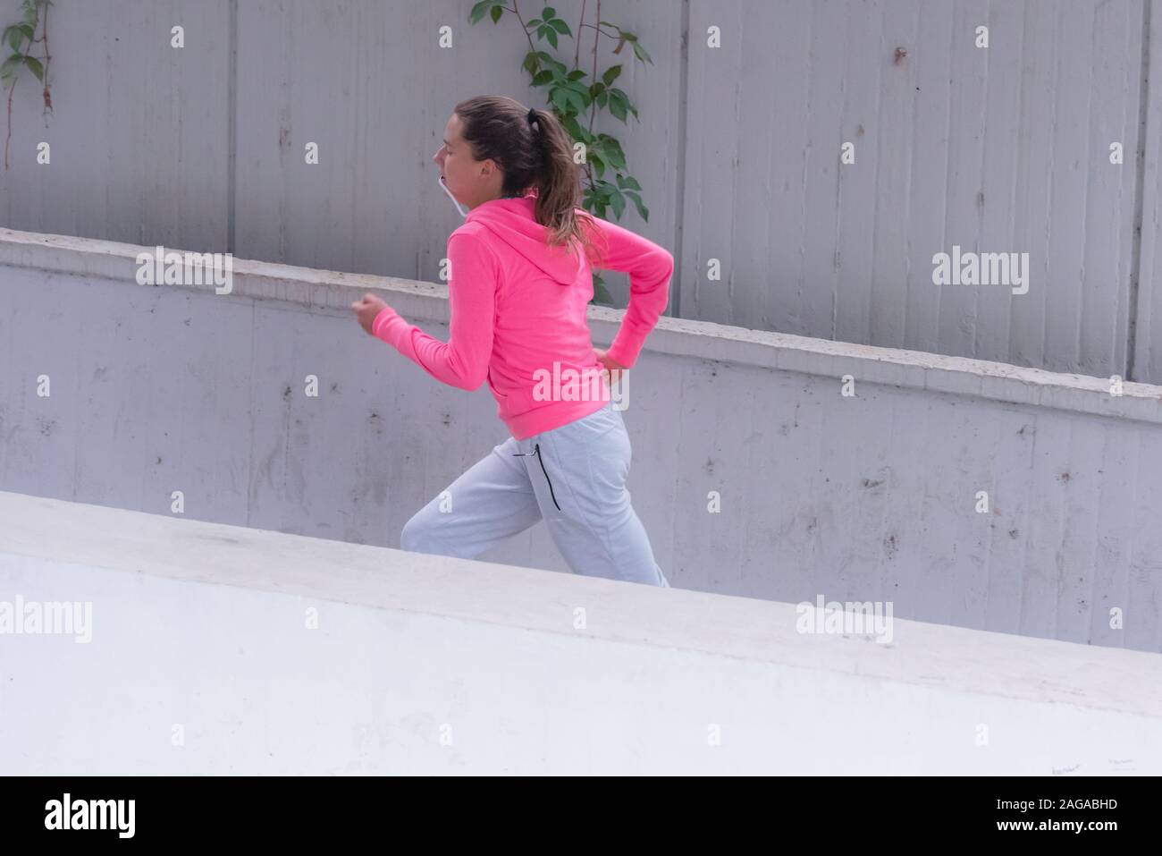 Running woman. Female fitness model training outside in the city Stock ...