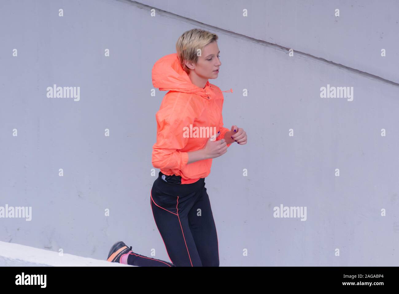 Running woman. Female fitness model training outside in the city Stock ...