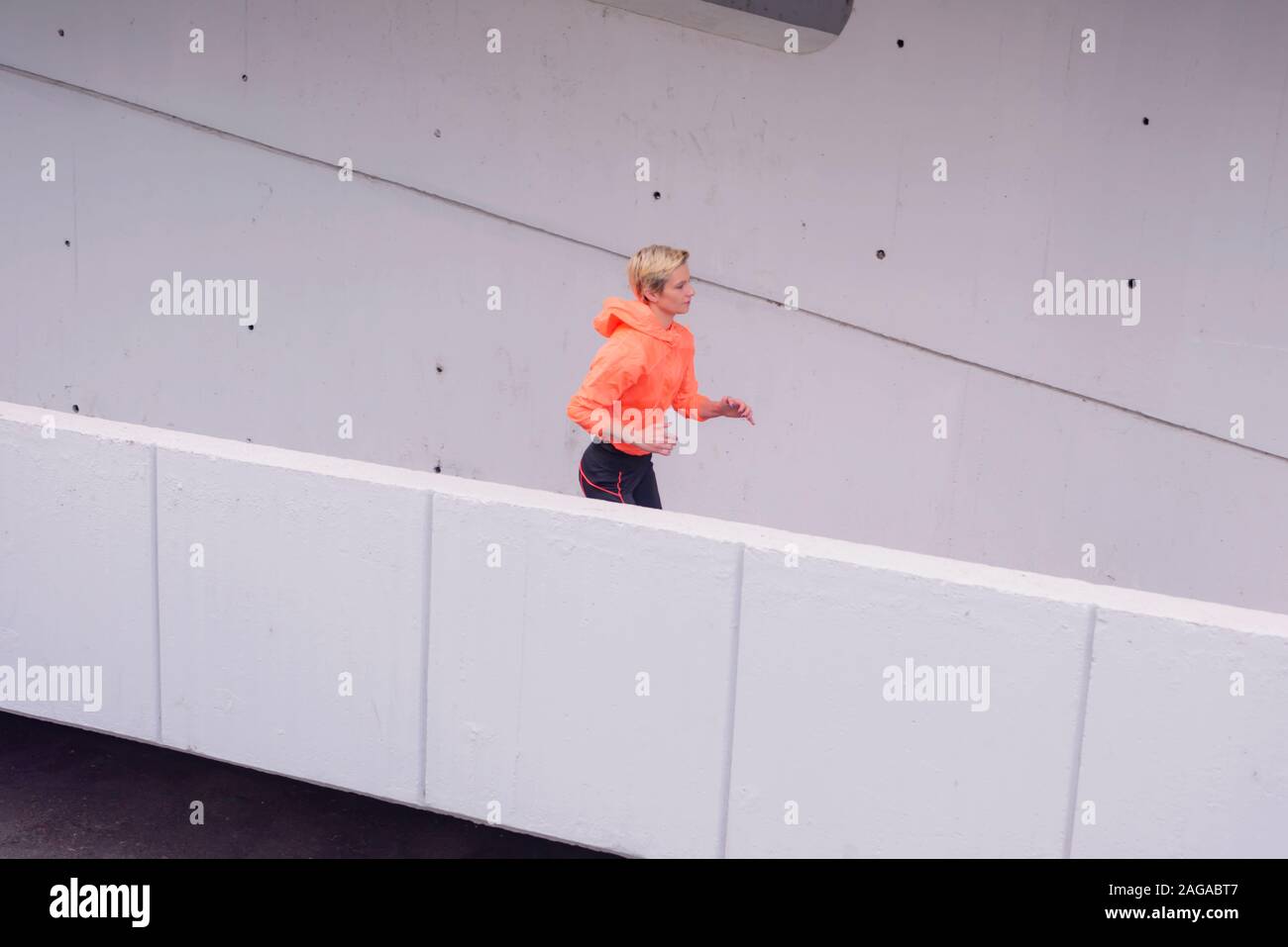 Running woman. Female fitness model training outside in the city Stock ...