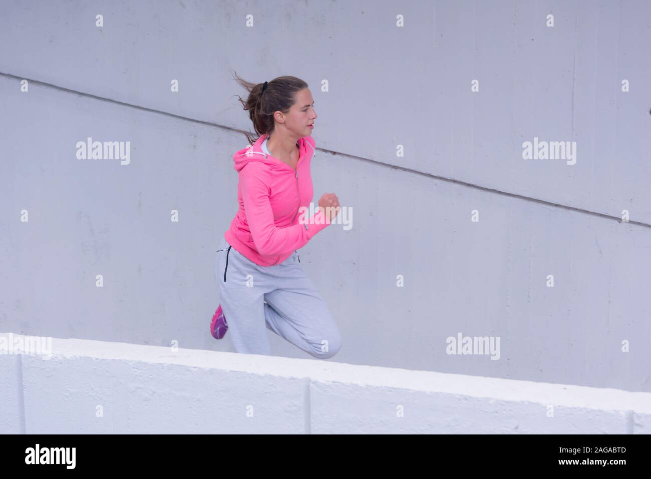 Running woman. Female fitness model training outside in the city Stock ...