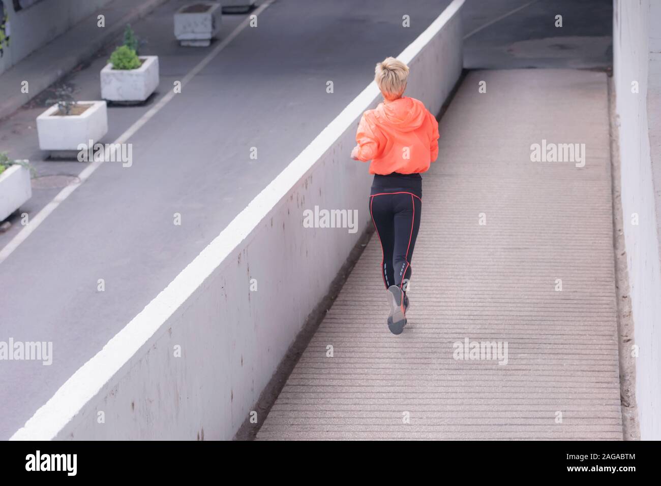 Running woman. Female fitness model training outside in the city Stock ...
