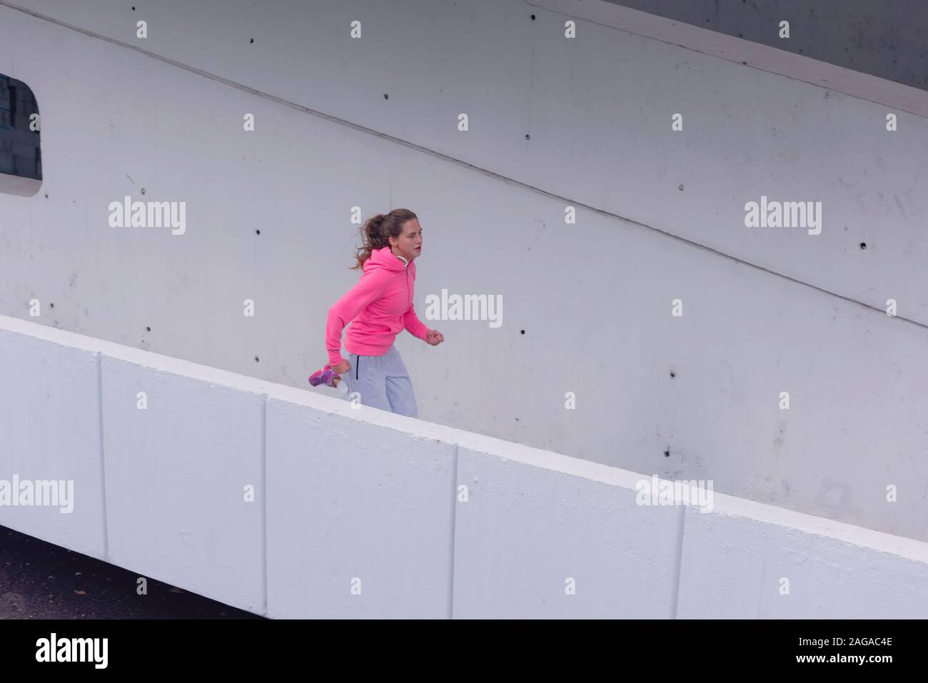 Running woman. Female fitness model training outside in the city Stock ...