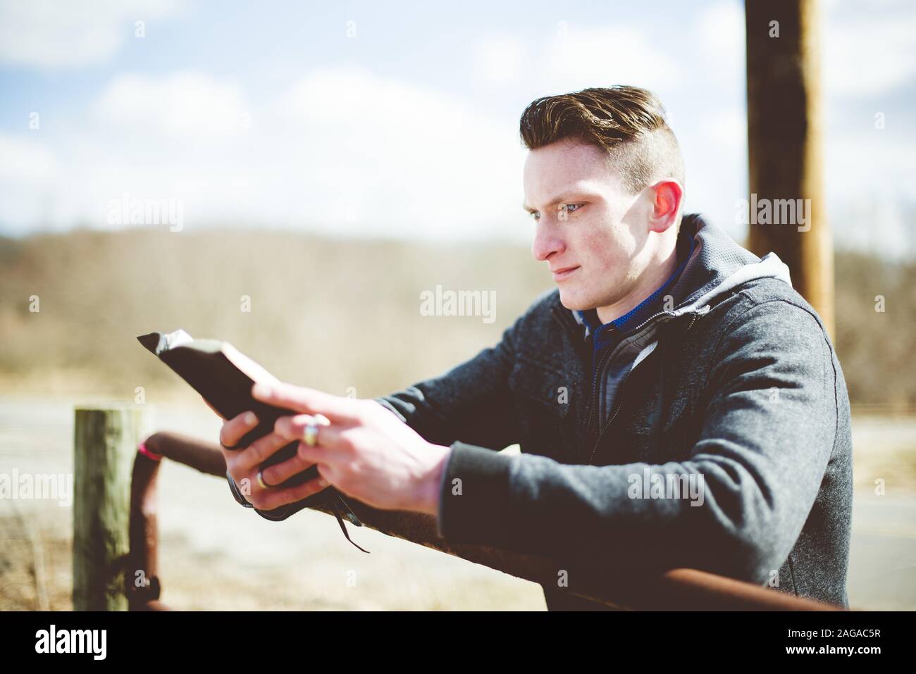 Shallow focus shot of a male reading the bible Stock Photo - Alamy