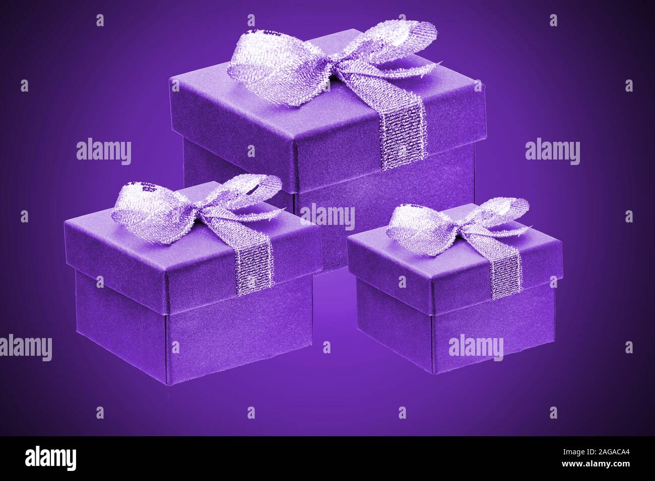 three purple gift boxes on a purple gradient background. close up Stock ...