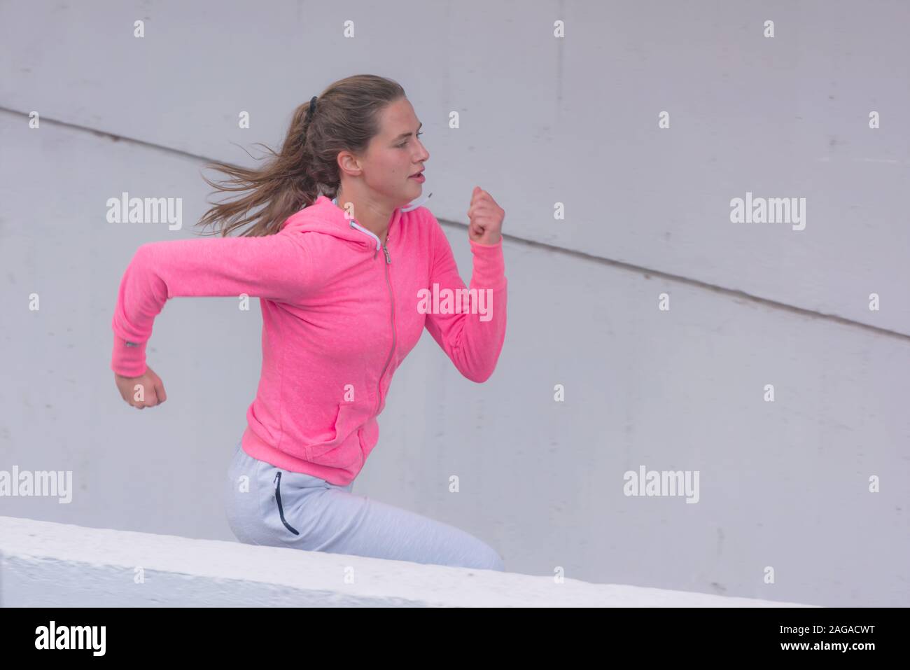 Running woman. Female fitness model training outside in the city Stock ...