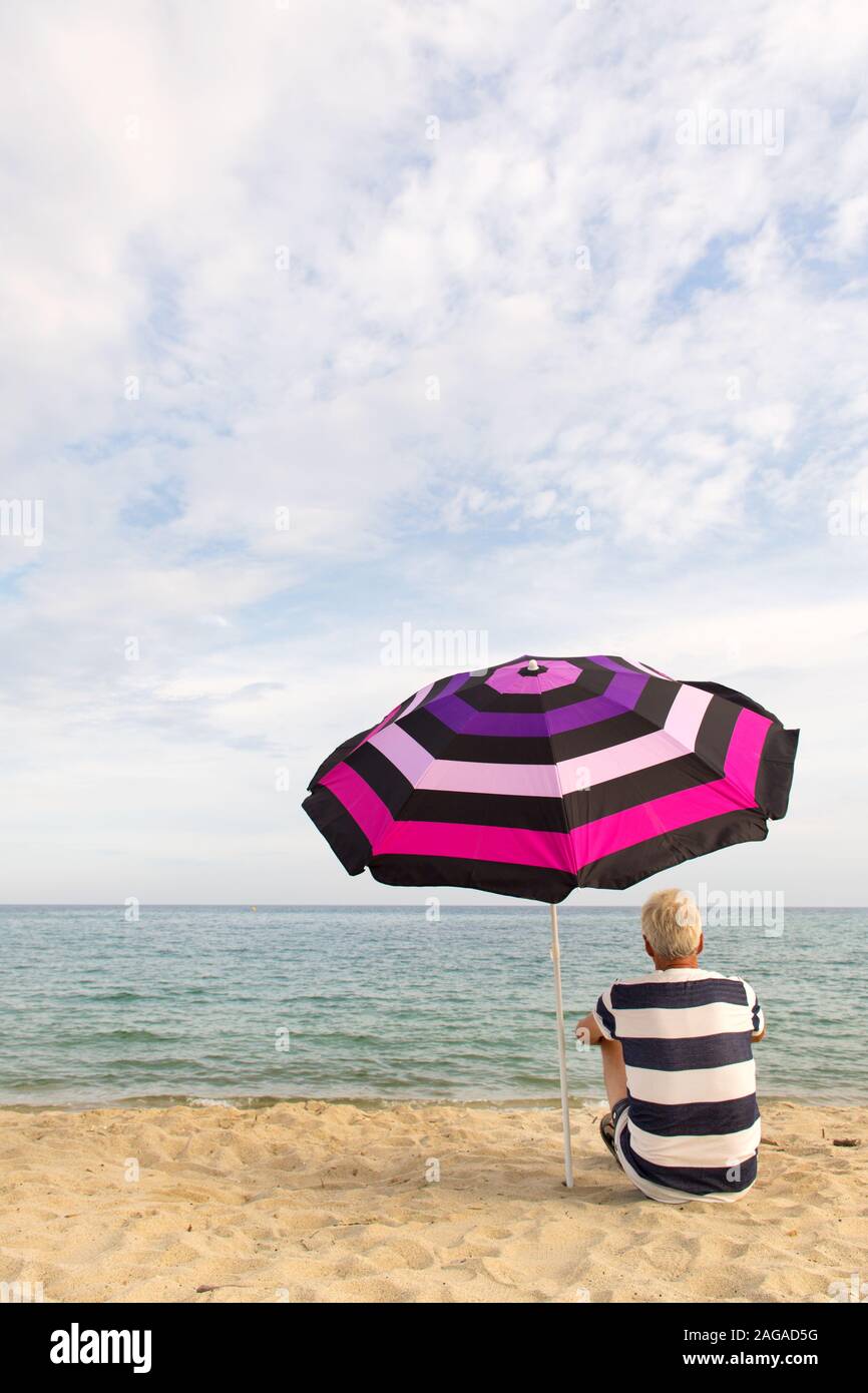 Man beach relax under parasol hi-res stock photography and images - Alamy