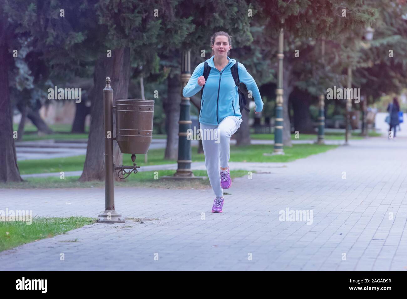 Running woman. Female fitness model training outside in the city Stock ...