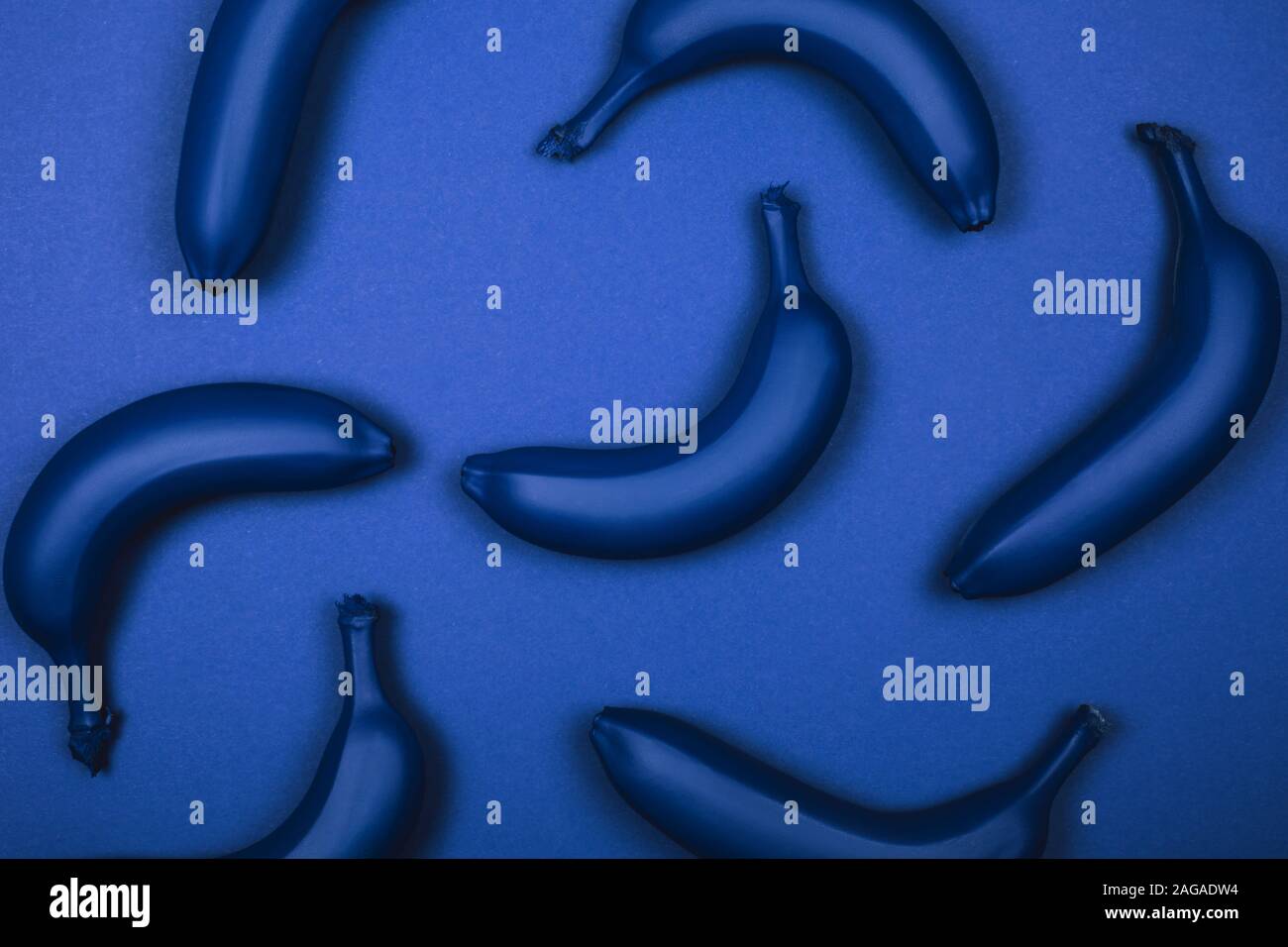 Dark blue bananas on blue. Flat lay style. Monochrome trendy photo ...