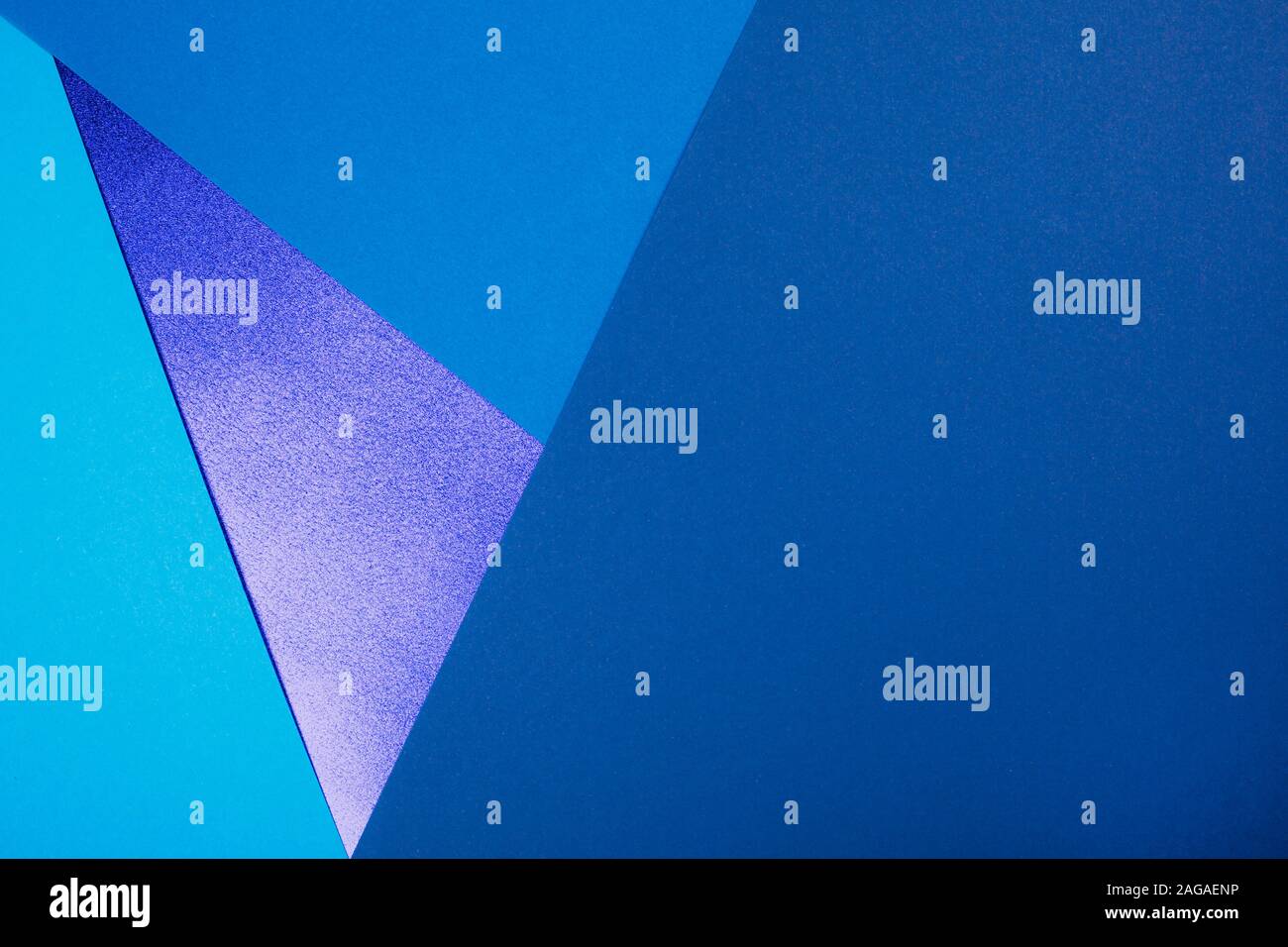 Divided in several parts blue paper background with metallic elemments ...