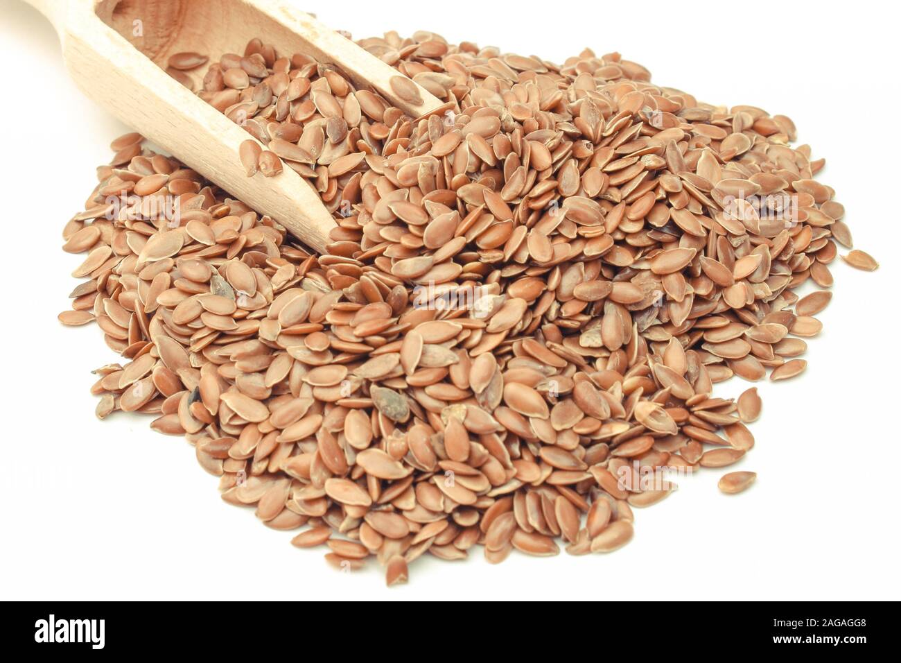 Linseed with wooden spoon on white background. Concept of healthy food containing dietary fiber ...