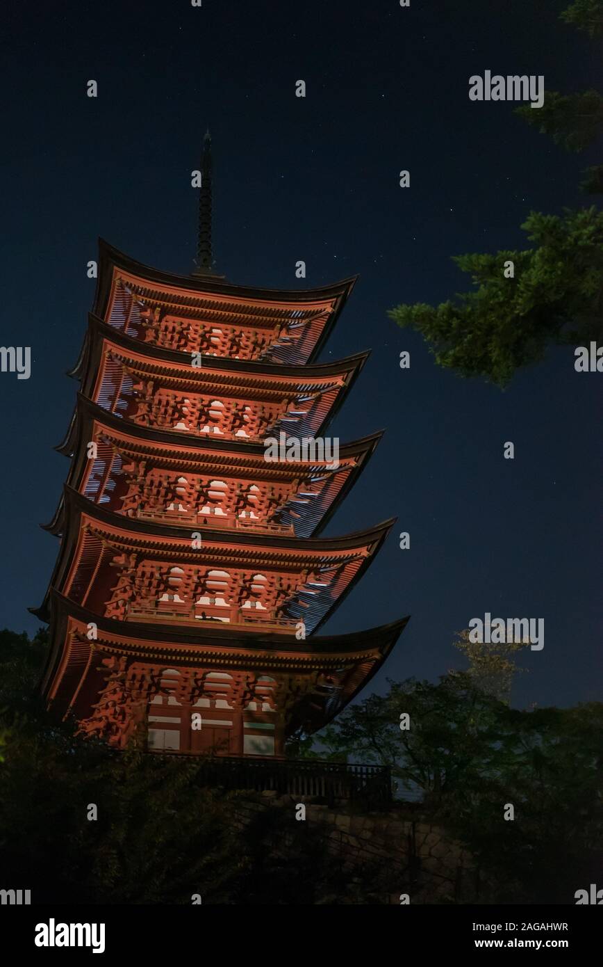 Vertical shot of the Miyajima Island Temple captured at night in Japan ...