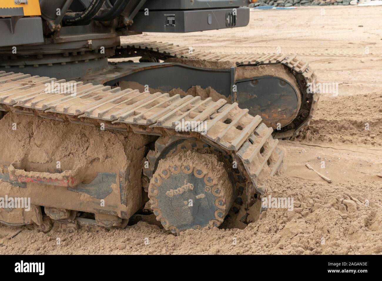 A close up view of a volvo grader digging up sand on Durban beach Stock ...