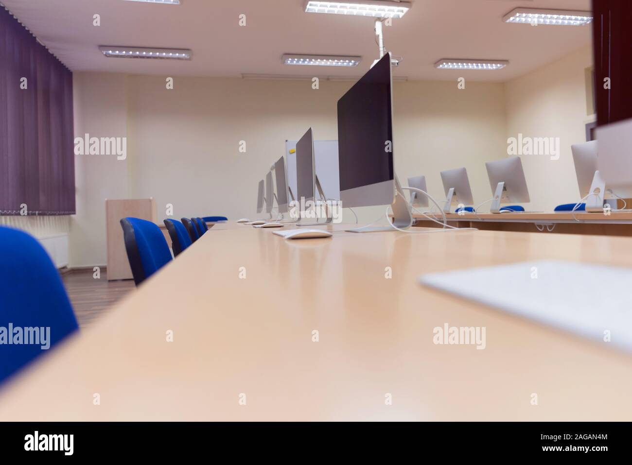 Modern office with computers on desks. Empty computer room in college ...
